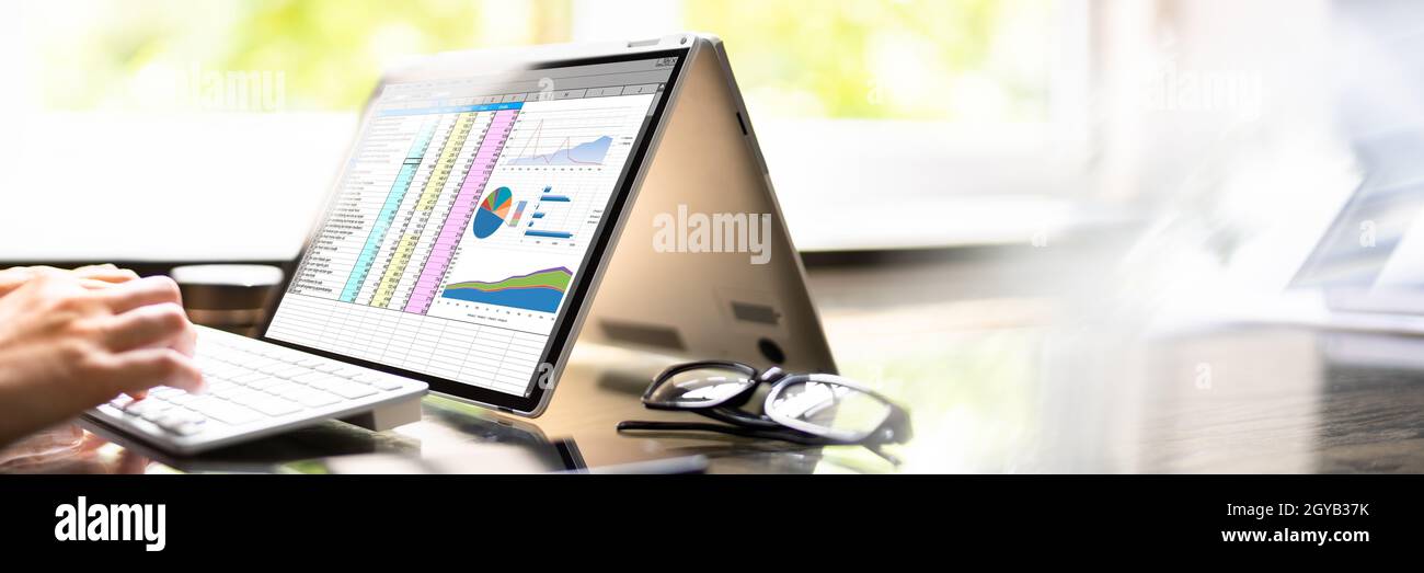 Spreadsheet Graphs On Laptop Screen. Working With Reports Stock Photo - Alamy