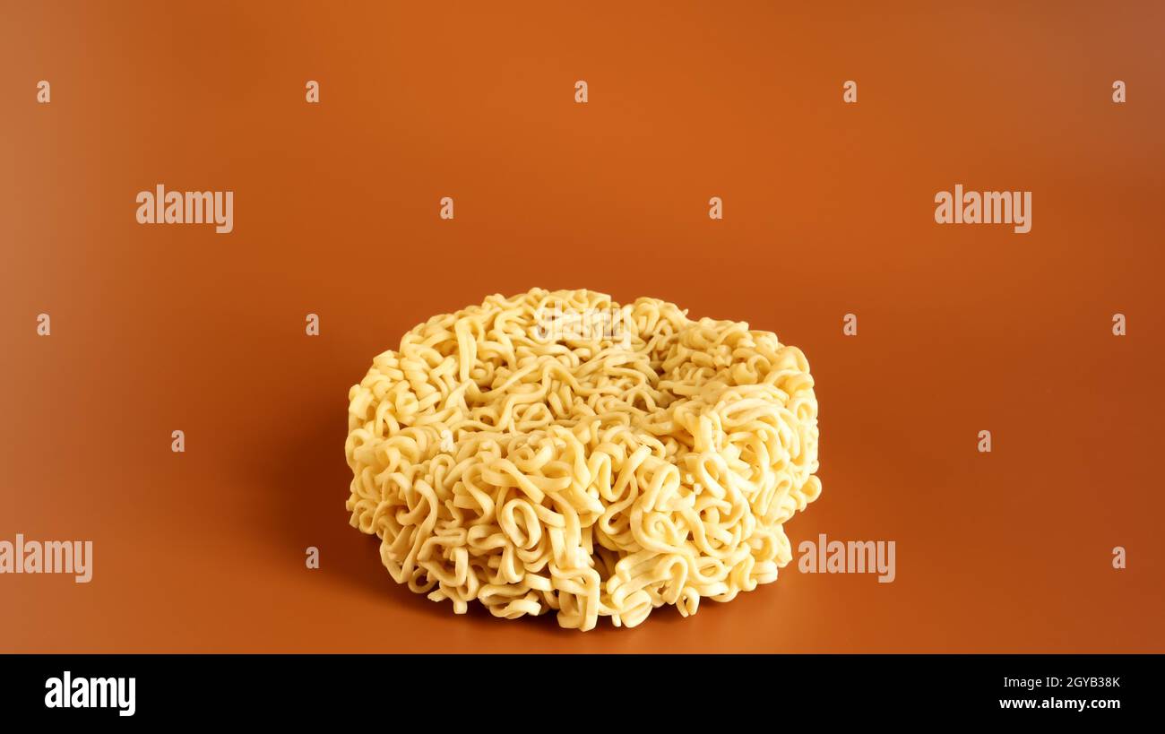 Korean instant noodles in the shape of a circle on a brown background ...