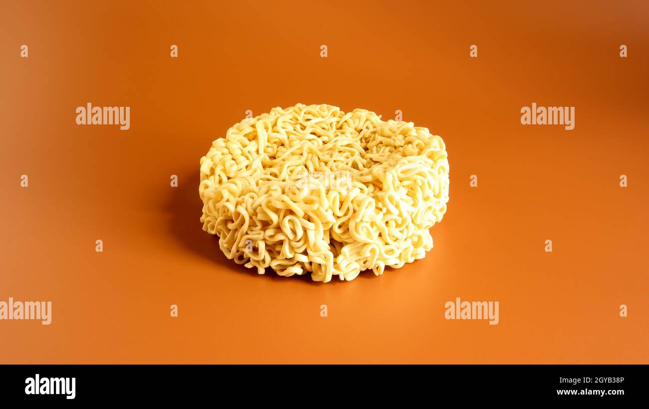 Korean instant noodles in the shape of a circle on a brown background ...