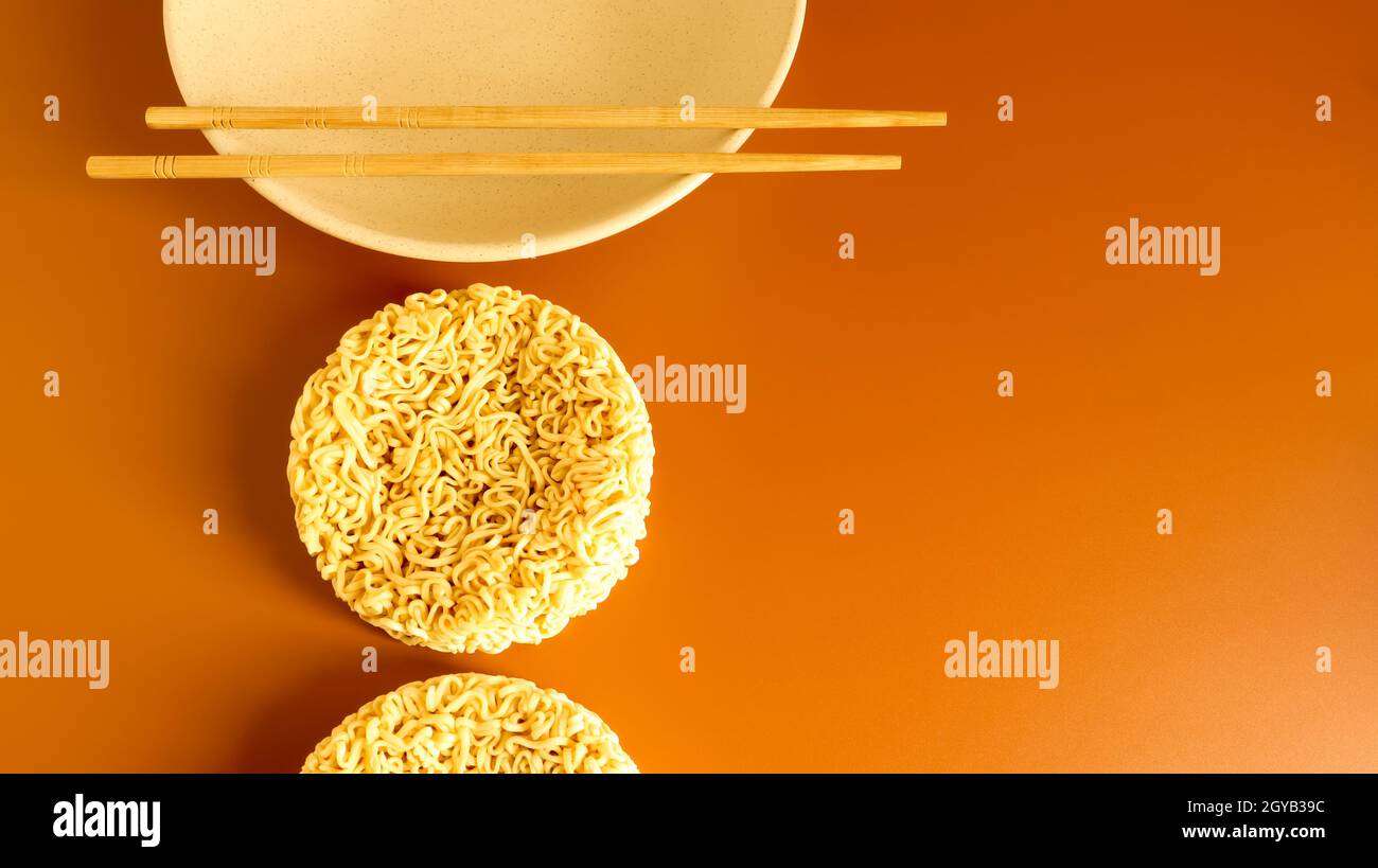 dry instant noodles in a typical circle shape on a plate with ...