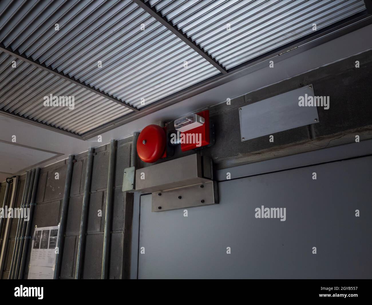 Electric red fire ring bell alarm on the wall in system room Stock ...