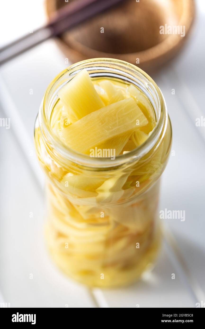 Sliced canned bamboo shoots in jar on white table Stock Photo - Alamy
