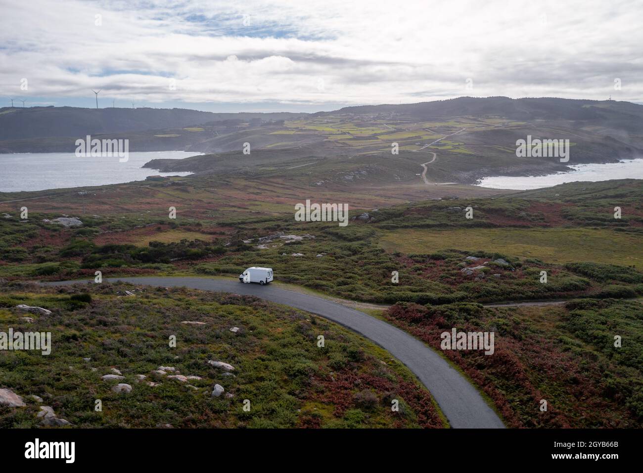 Drone aerial panoramic view of a camper van in green and red landscape ...