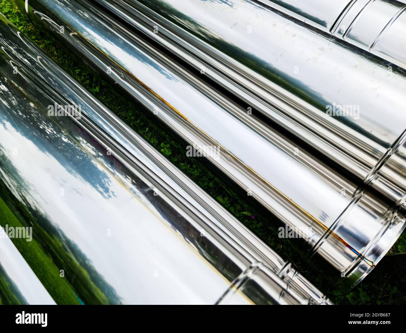 Selective focus view at a lot of reflective chrome metal tubes on a ...