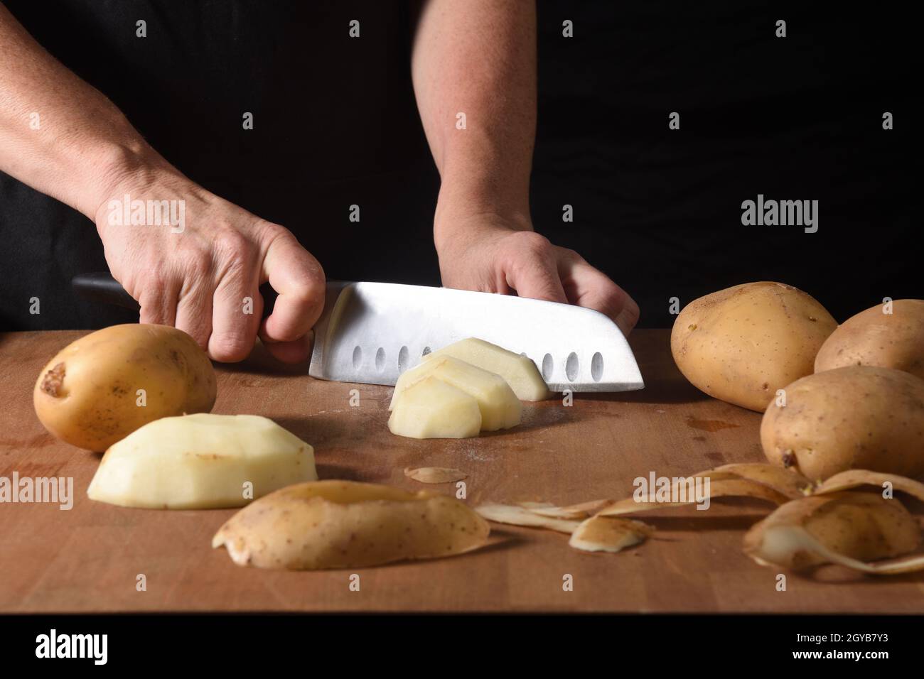 Hand cutting potato knife hi-res stock photography and images - Alamy