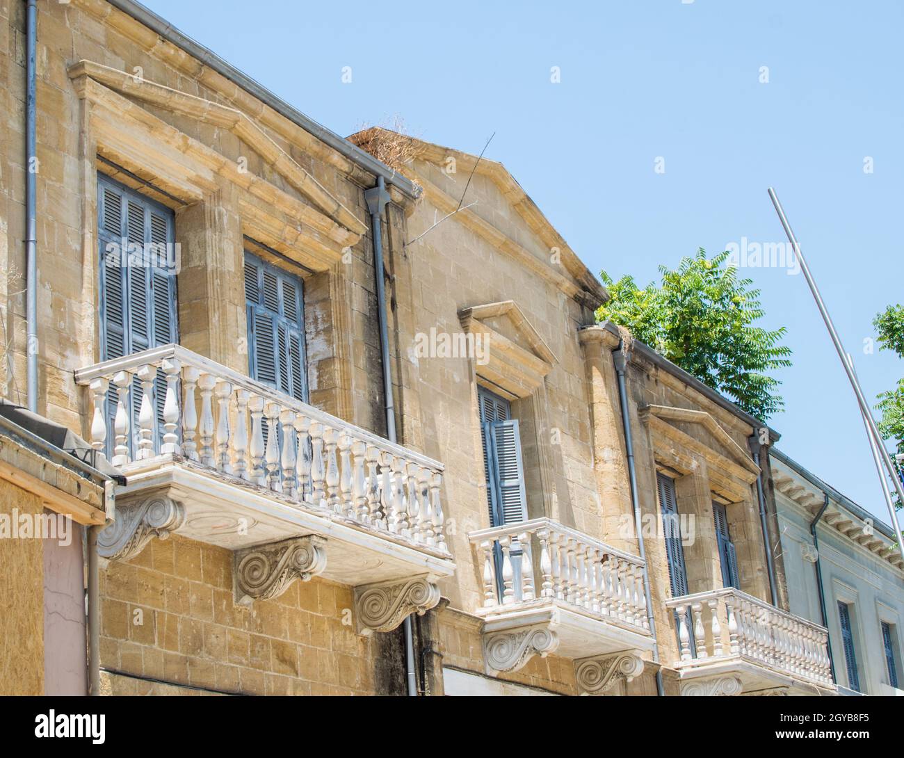 Facade of old neoclassic Greek house with balcony Stock Photo - Alamy