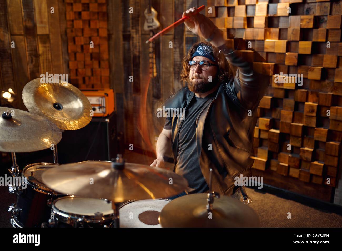 Brutal drummer behind the drum kit, music performing on stage. Rock ...