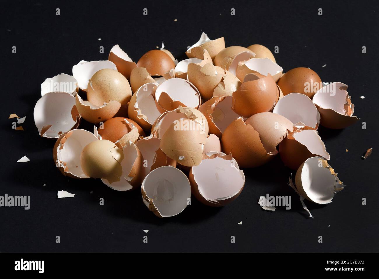 pile of eggshells on black background Stock Photo - Alamy