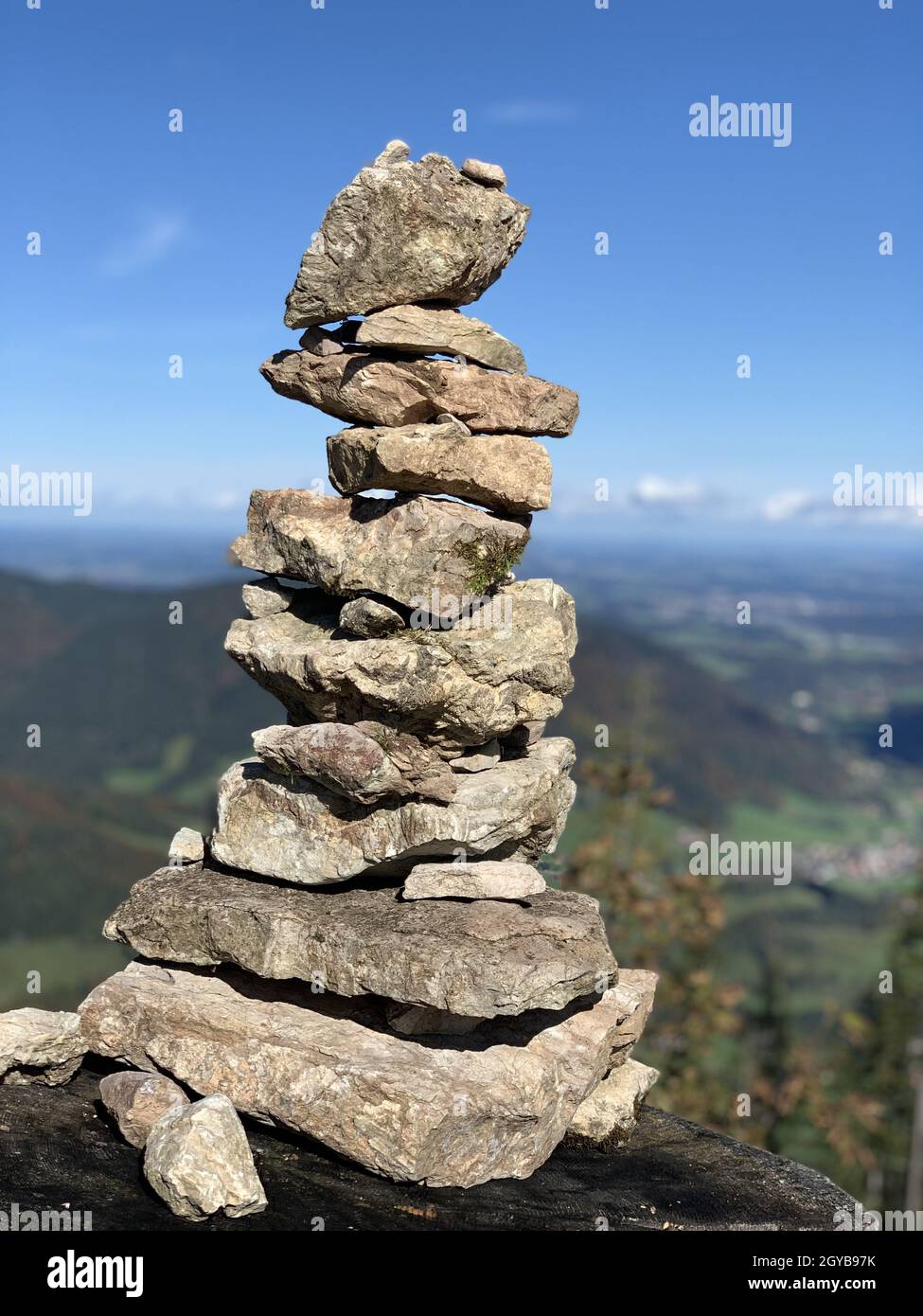 Vertical shot of a stack of rocks against a valley view Stock Photo - Alamy
