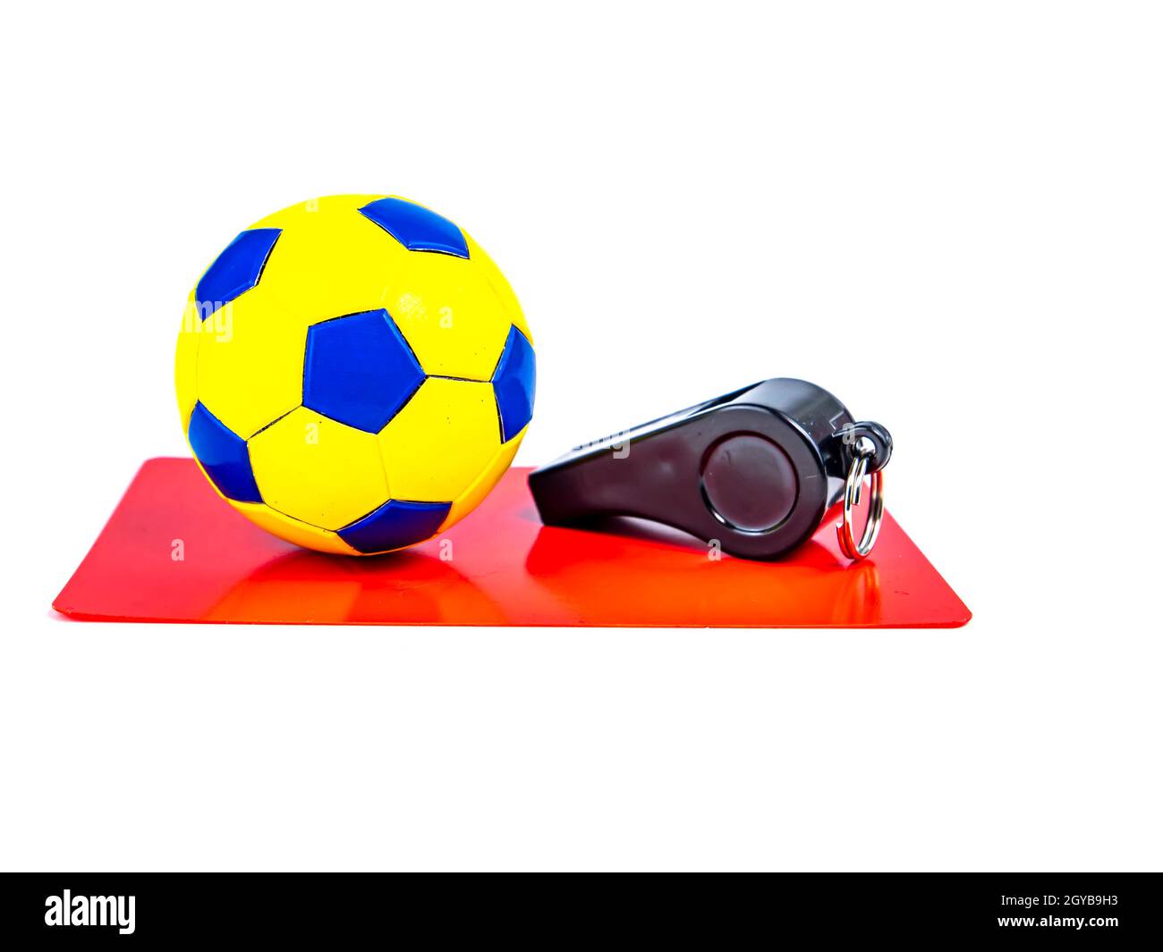 Soccer ball and red card with the whistle of a soccer referee on a ...