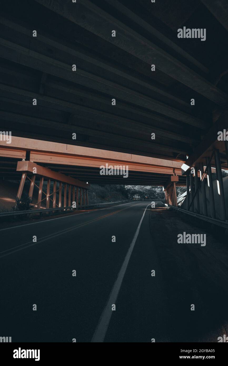 Asphalt road under a concrete bridge - urban photography in grayscale ... Asphalt road under a concrete bridge - urban photography in grayscale ...