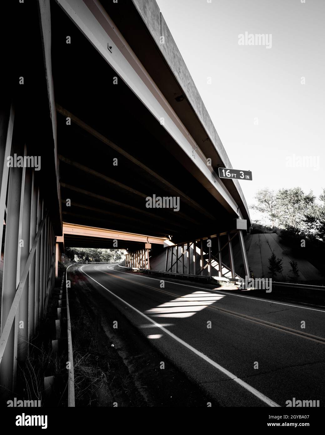Asphalt road under a concrete bridge - urban photography in grayscale ...