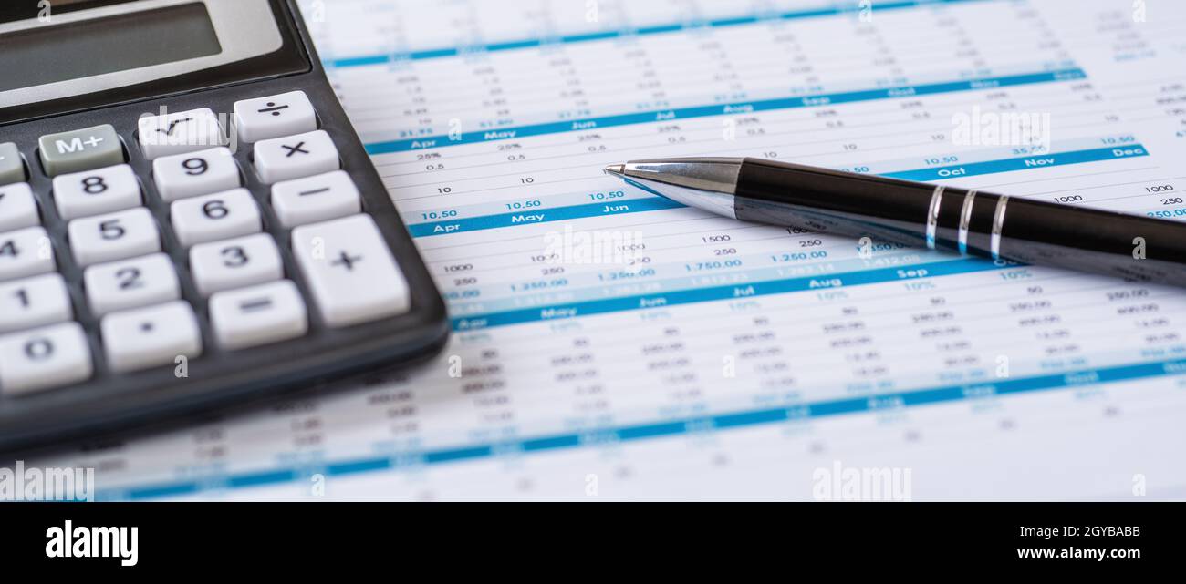 Financial documents with a calculator Stock Photo - Alamy