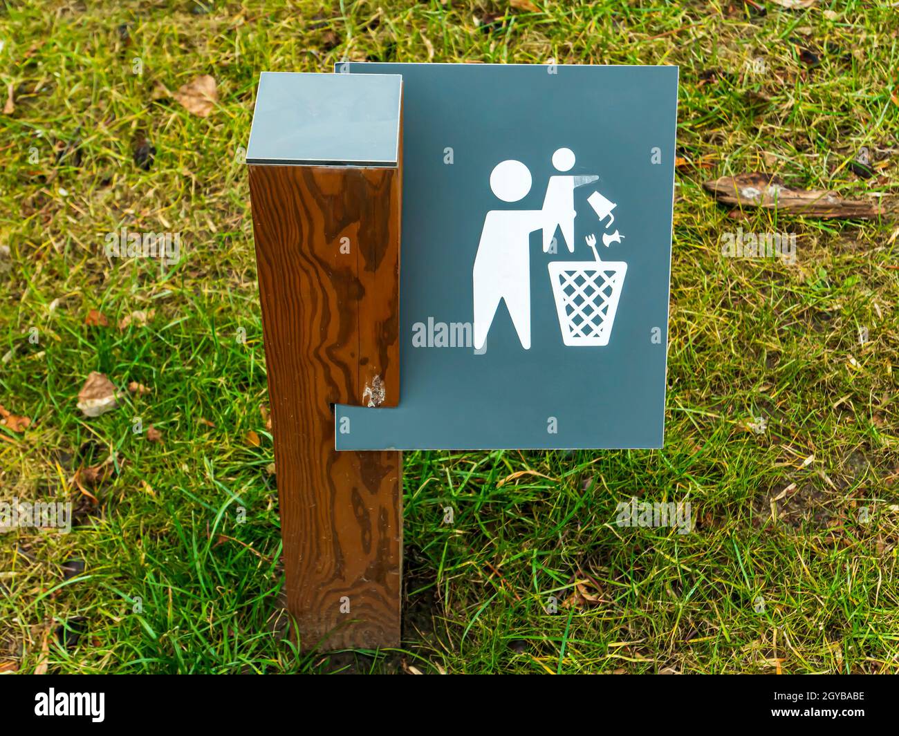 A warning sign about the rules of conduct in a public park. Background ...