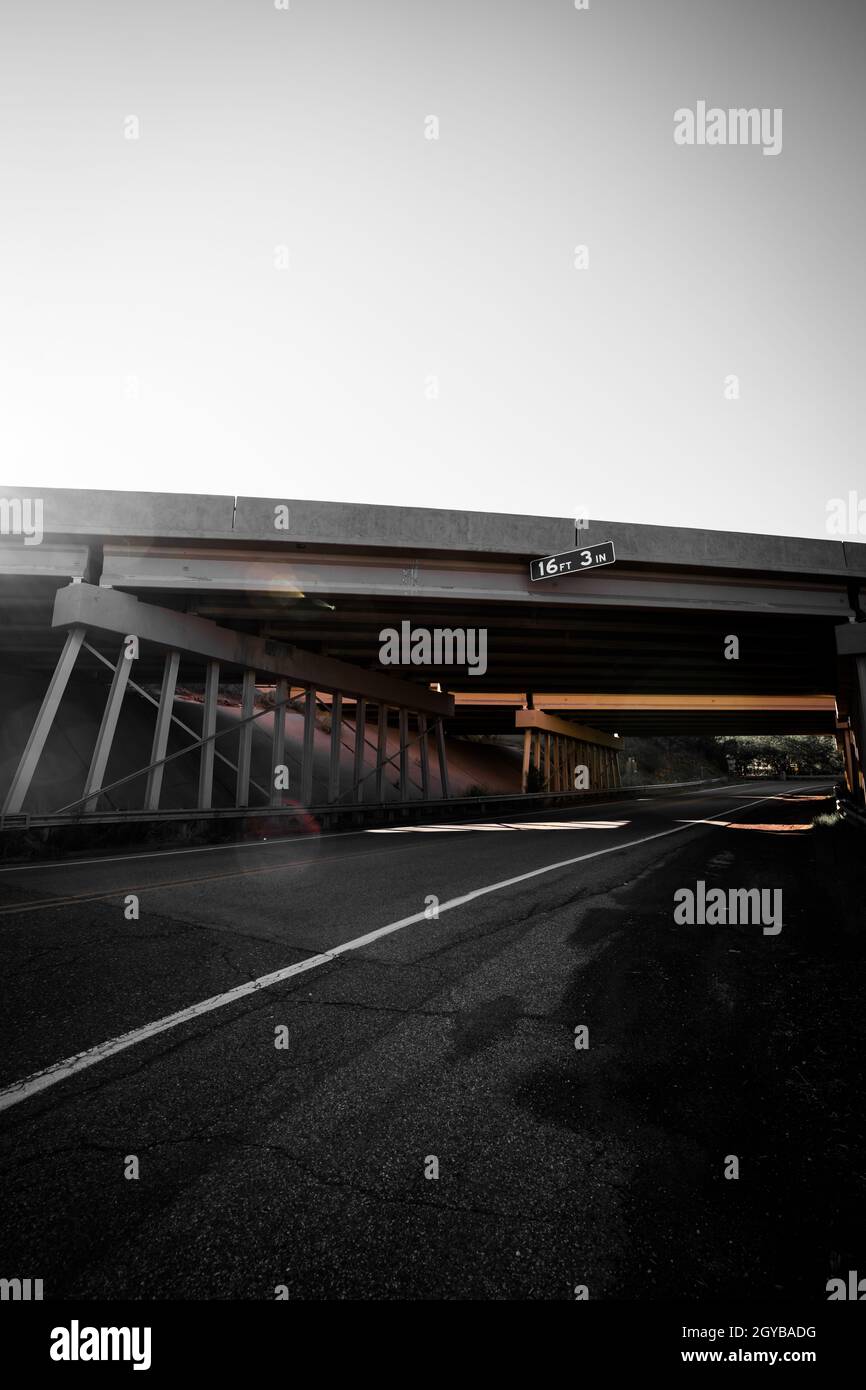 Asphalt road under a concrete bridge - urban photography in grayscale ...