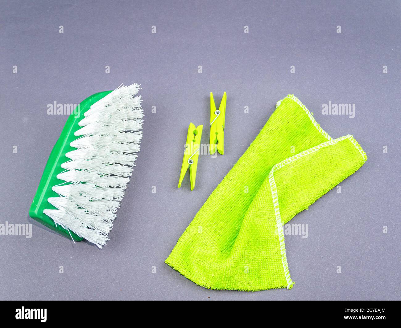 A brush with white bristles for cleaning rooms. Clothespins. Napkin for ...
