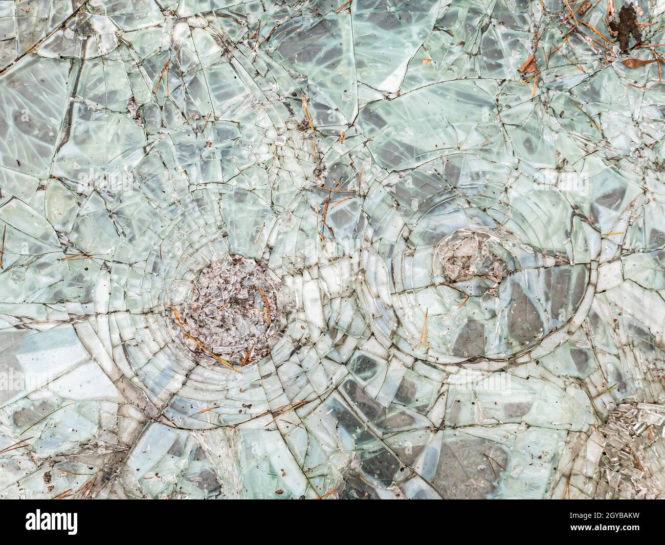 The glass surface is broken into small fragments. Place for text ...