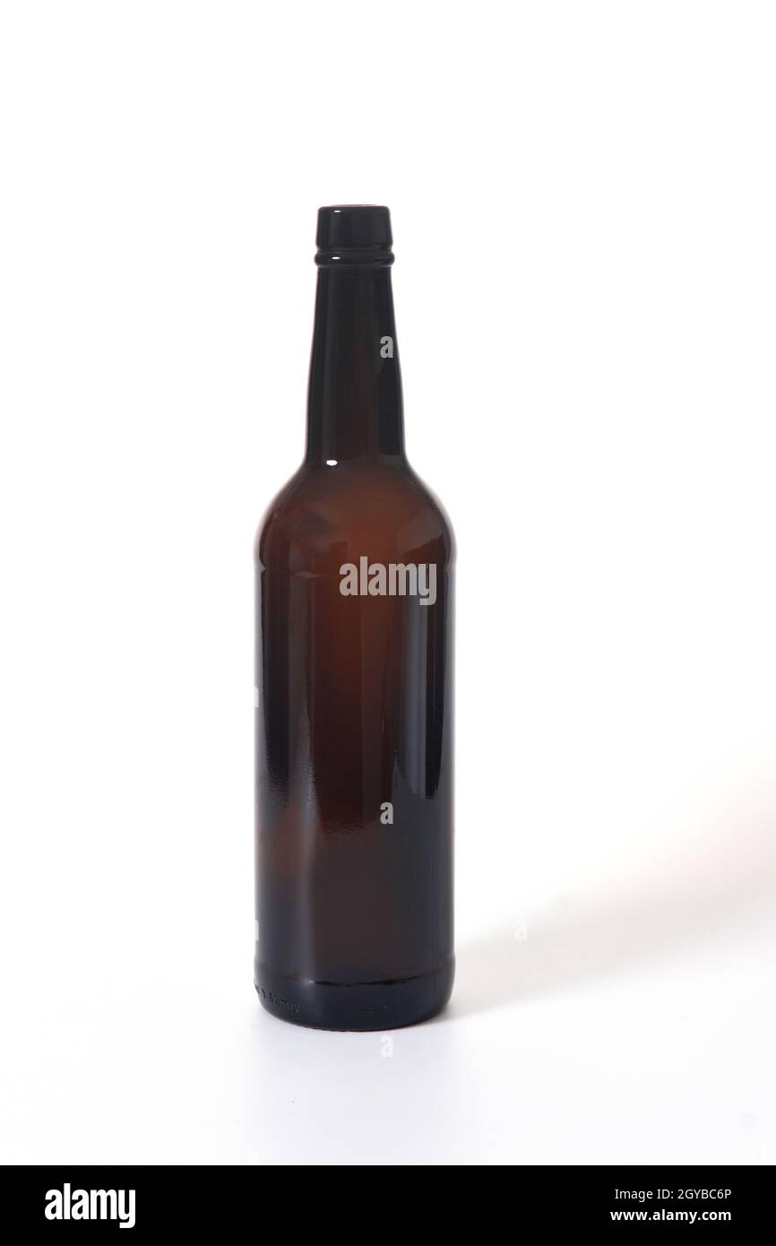 brown glass bottle of alcohol standing on white background Stock Photo ...