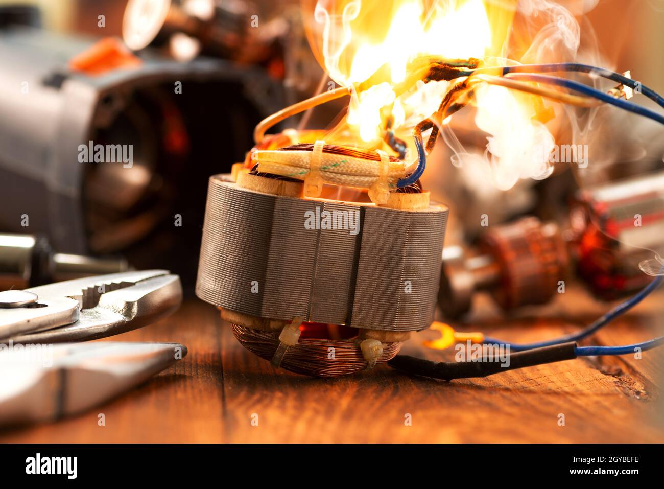 Burning wires on the details of an electrical appliance on a wooden ...