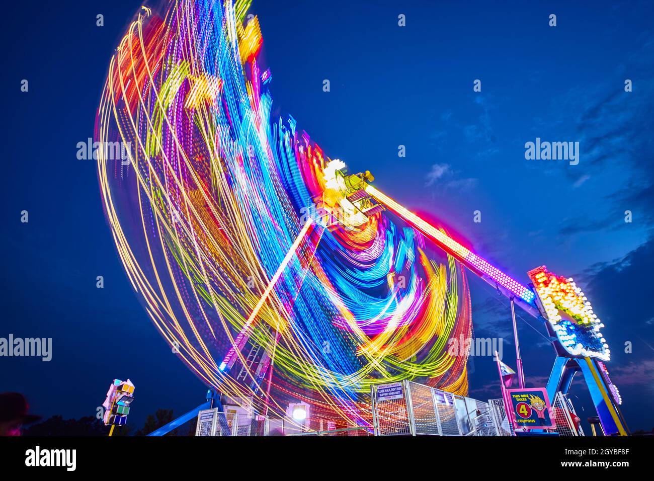 Carnival and fair ride caught in motion and full of color Stock Photo ...