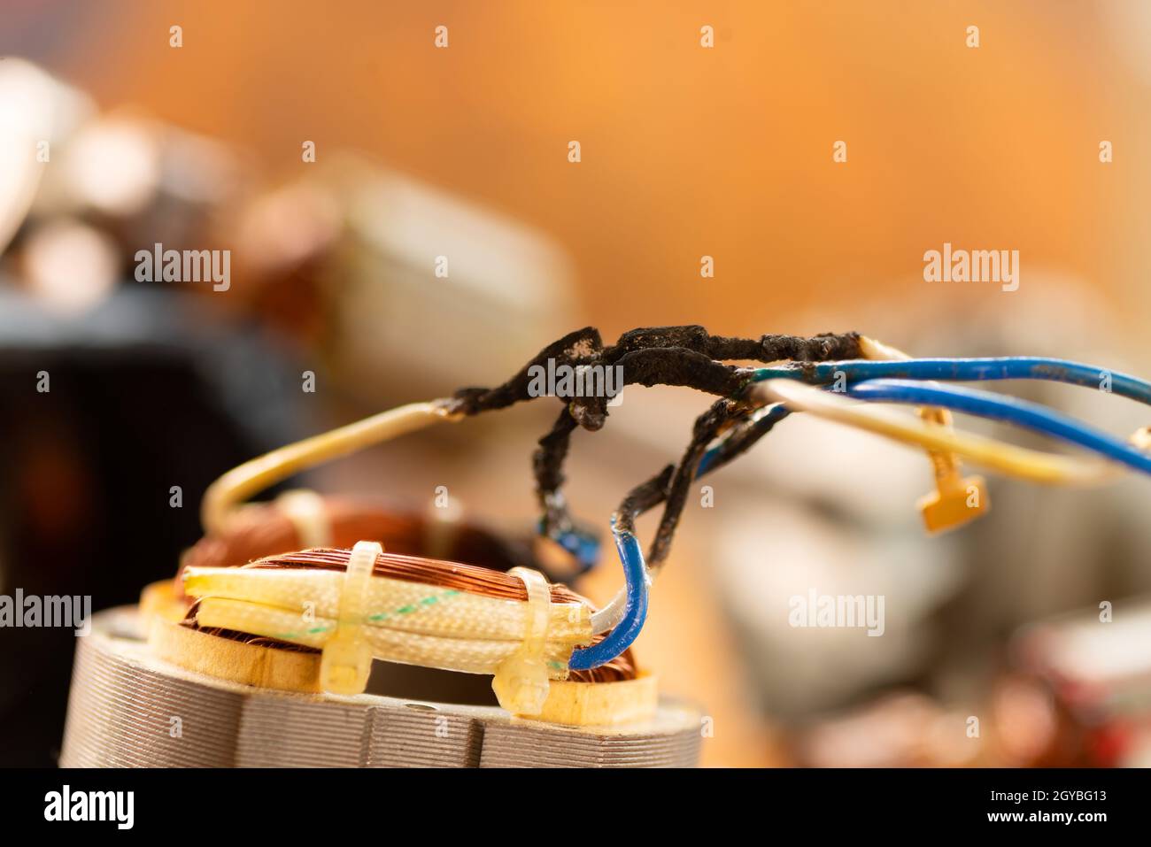 Burnt wires on the parts of an electrical appliance, drills on a wooden ...