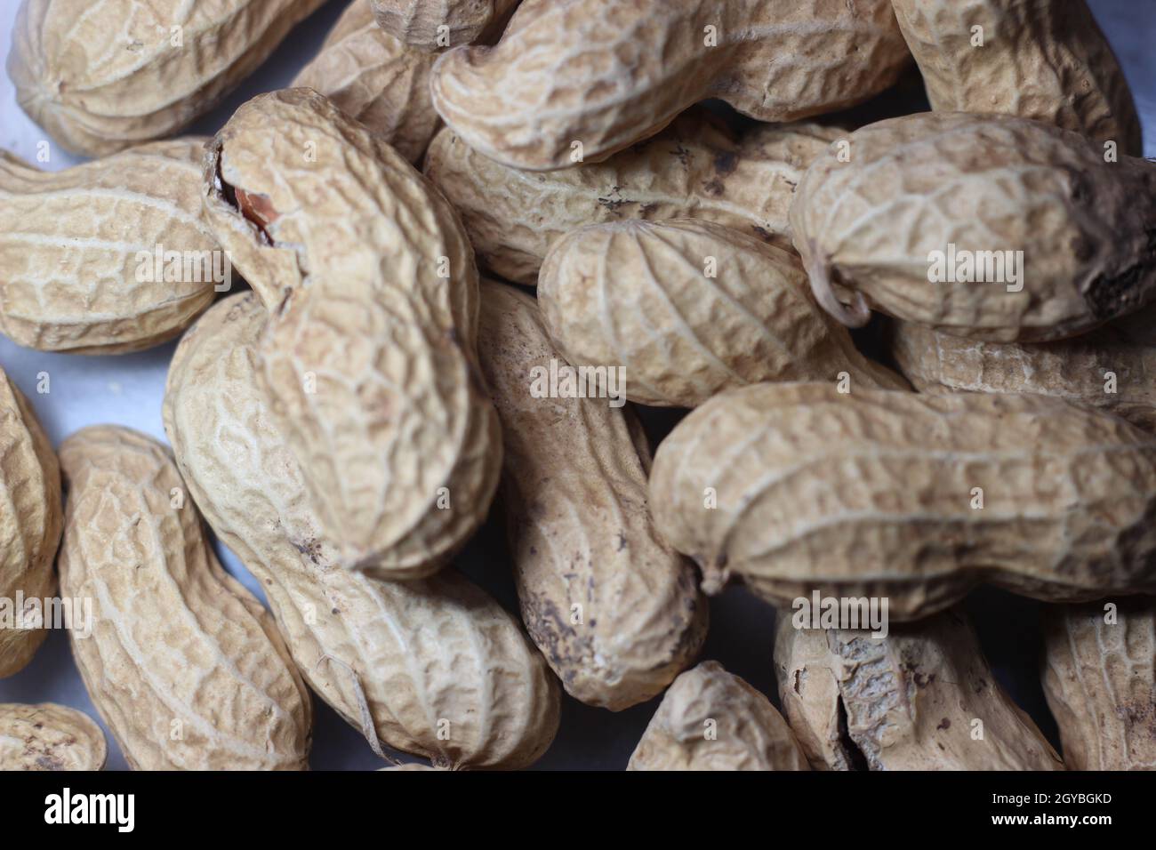 Unpeeled peanut with shells. Food background of peanuts Stock Photo - Alamy