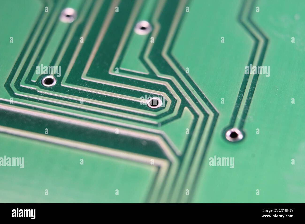 Electronic board with circuit lines and chip. Macro view of green board ...