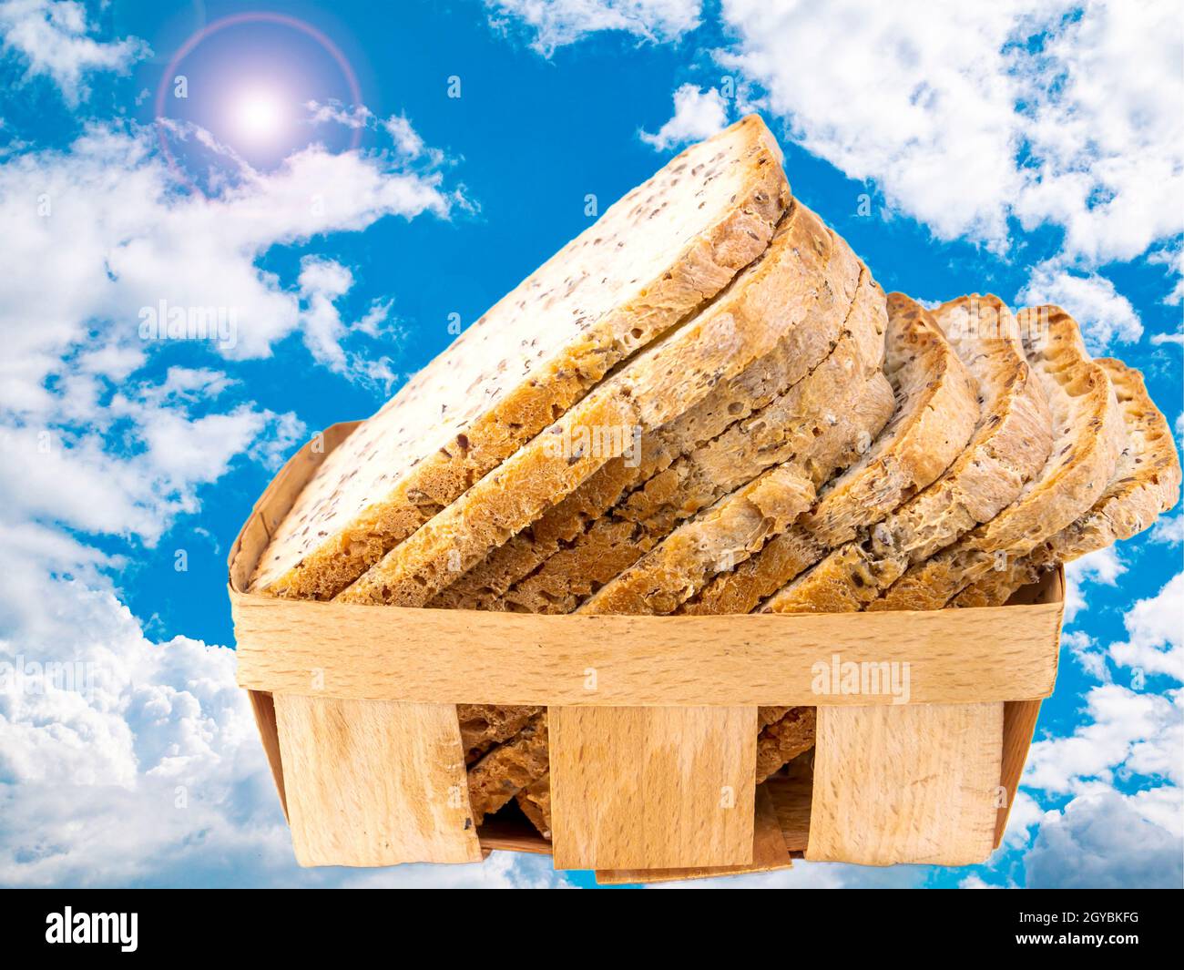 Basket with bread on a background of blue sky with clouds. God's gift ...