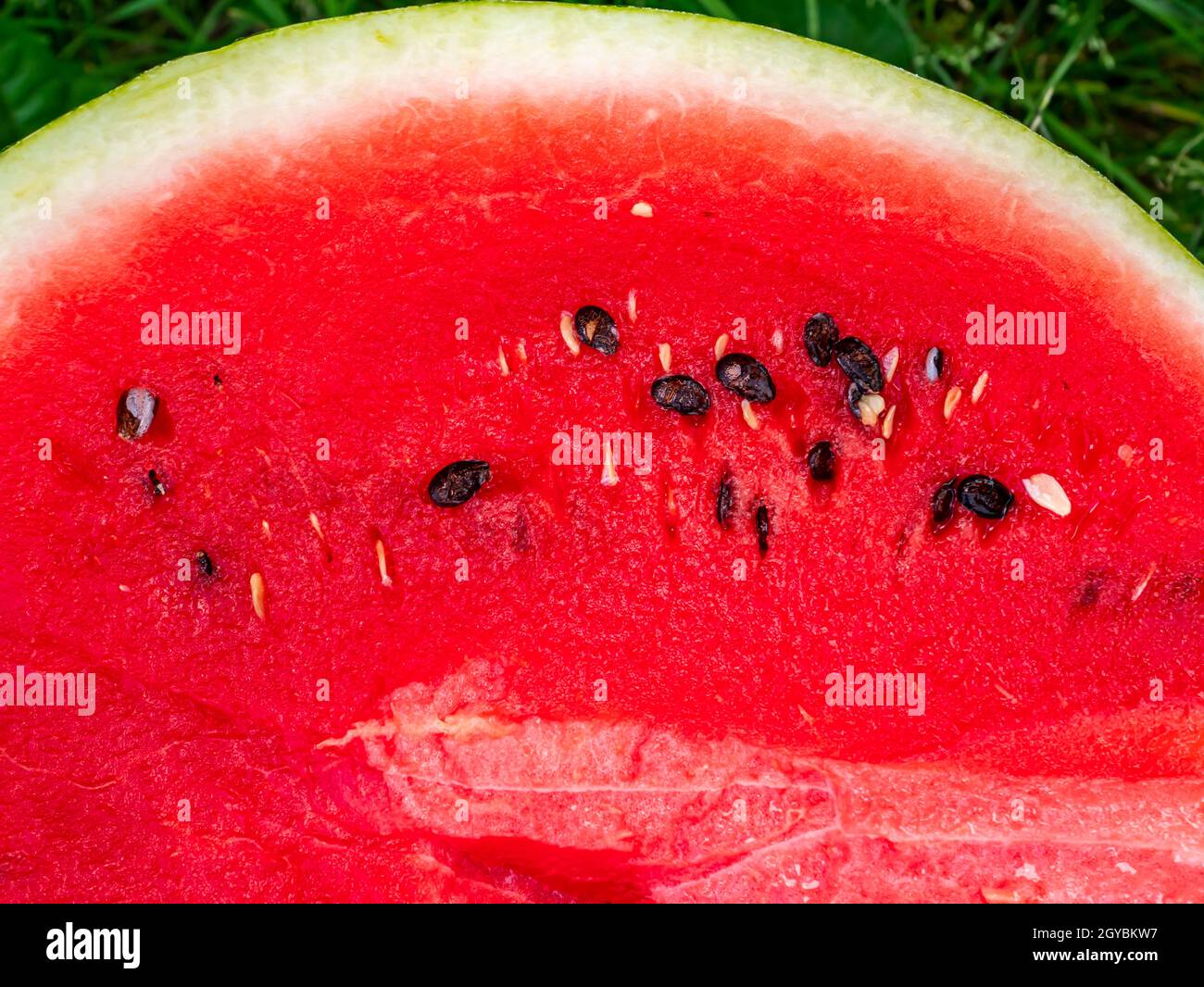 Red watermelon with seeds cut with a knife. Berry. Food photo. Place ...