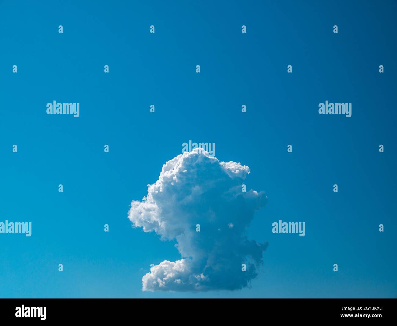 White cumulus cloud against blue sky in sunlight. Cloudy landscape ...