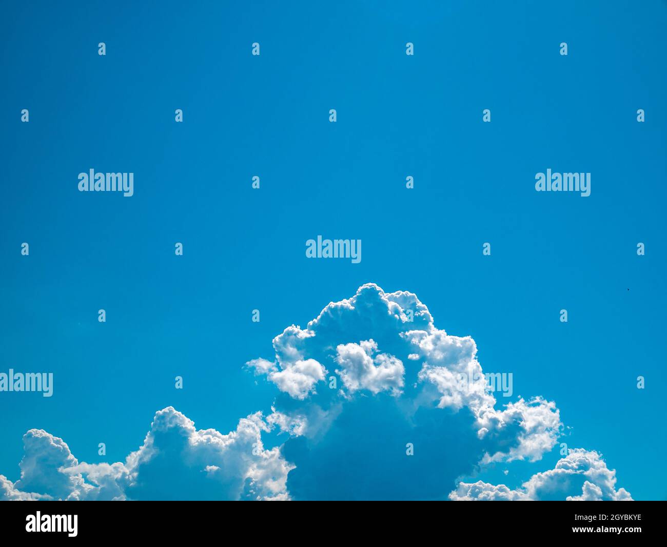White cumulus cloud against blue sky in sunlight. Cloudy landscape ...