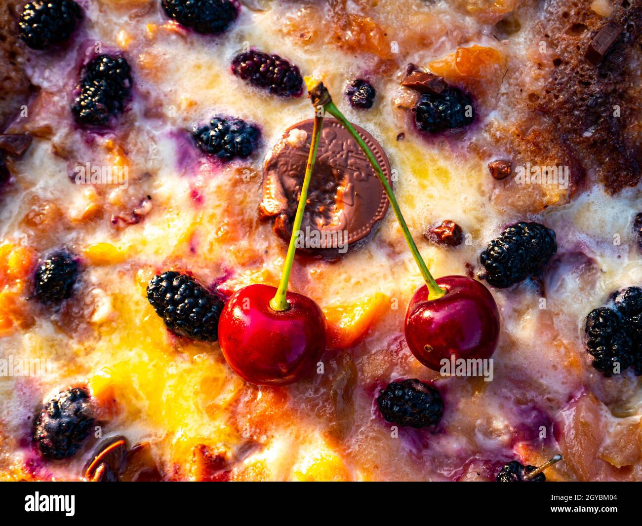 A cake decorated with two red cherries. Homemade baking. Dessert. Food ...