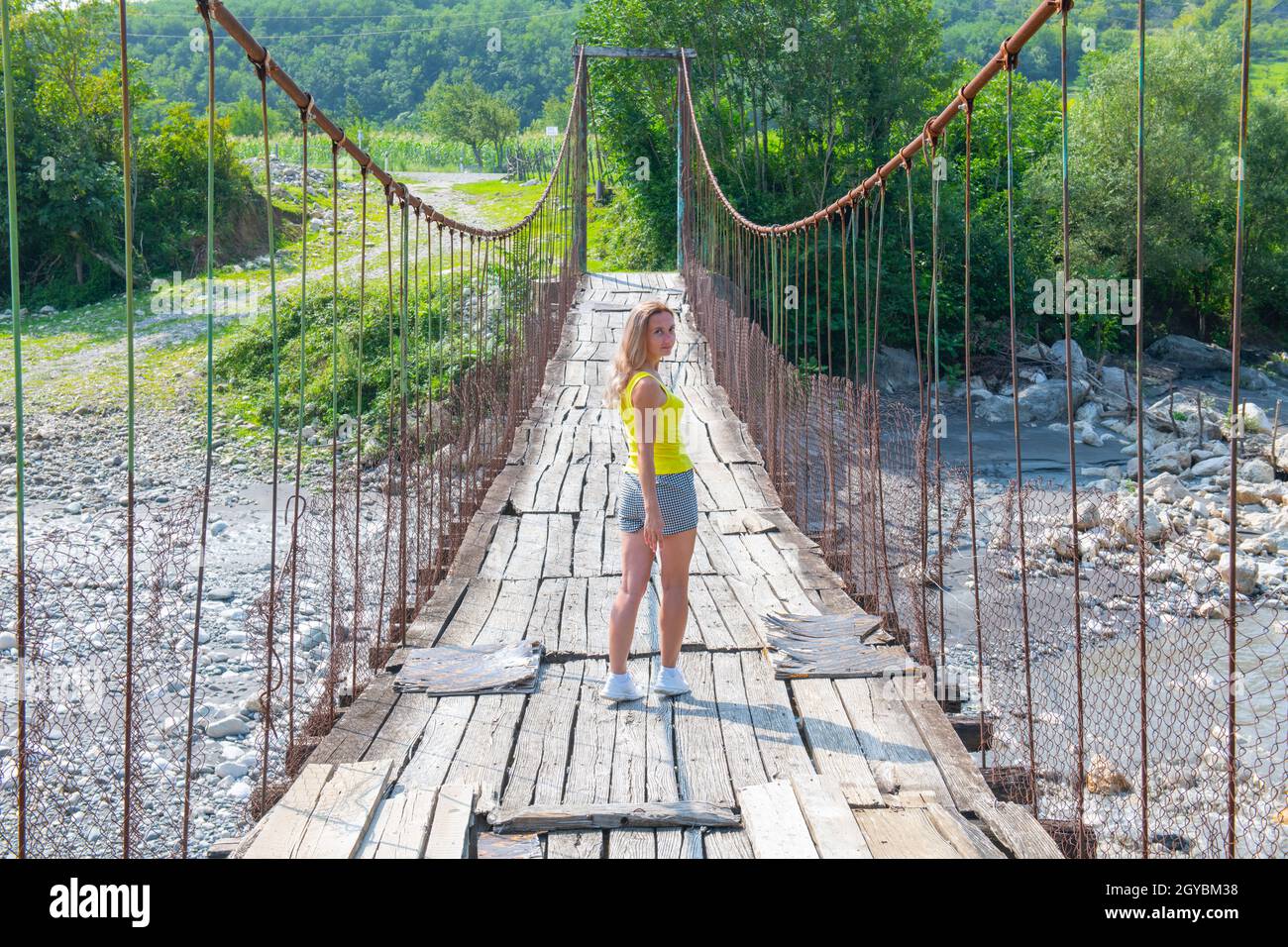 a woman stands on a suspension bridge in Georgia Stock Photo - Alamy