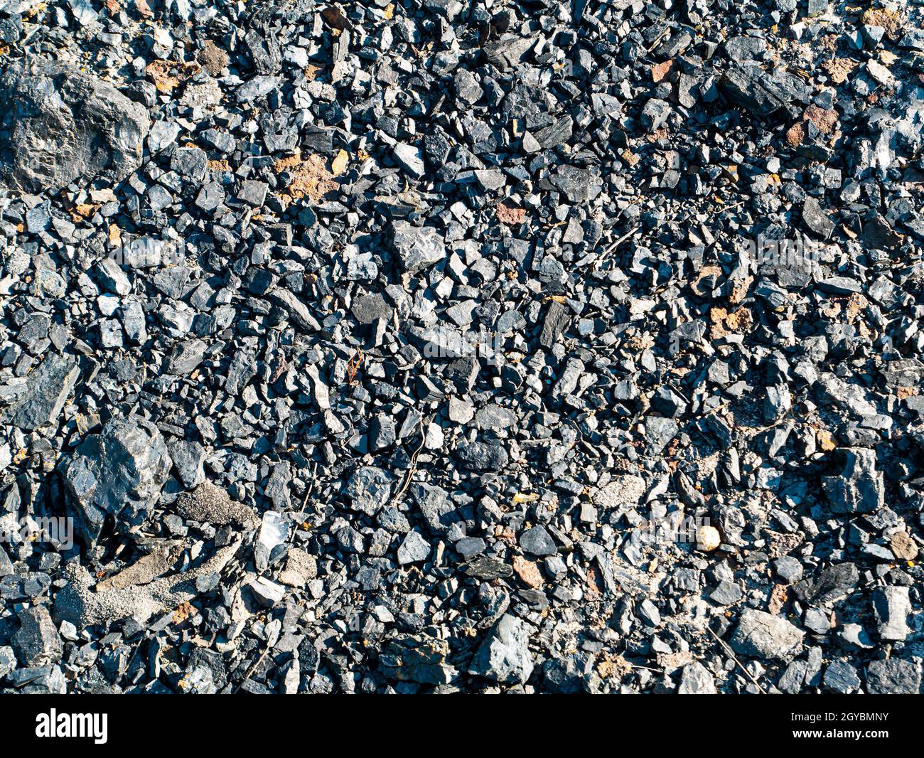 Lumps of black coal on the surface of the earth. Coal mining industry ...