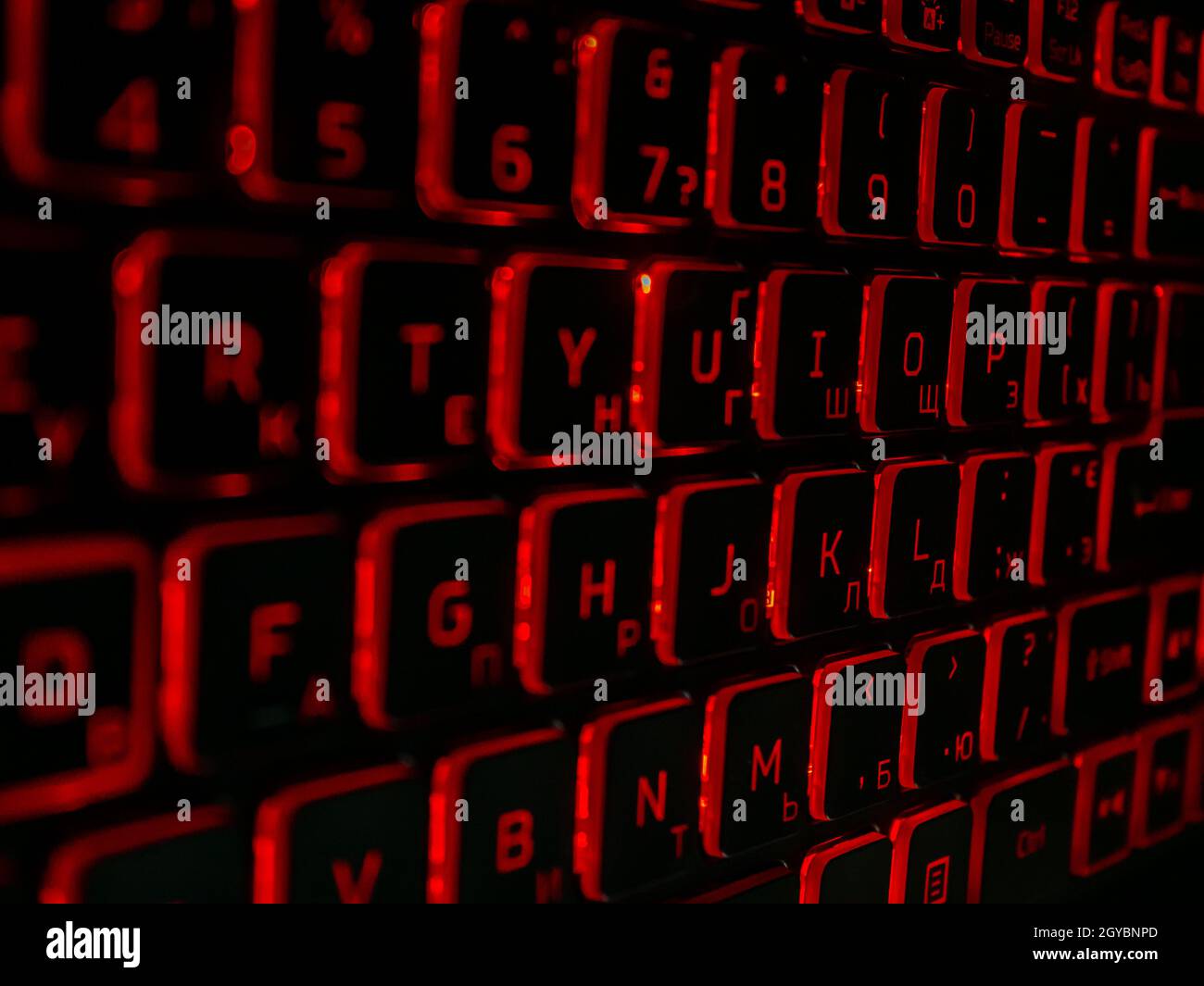 Black computer keyboard with red backlight in the dark. Laptop keyboard ...