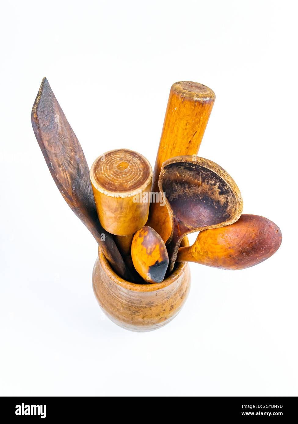 Ceramic clay jug with wooden kitchen utensils. Old kitchen utensils ...