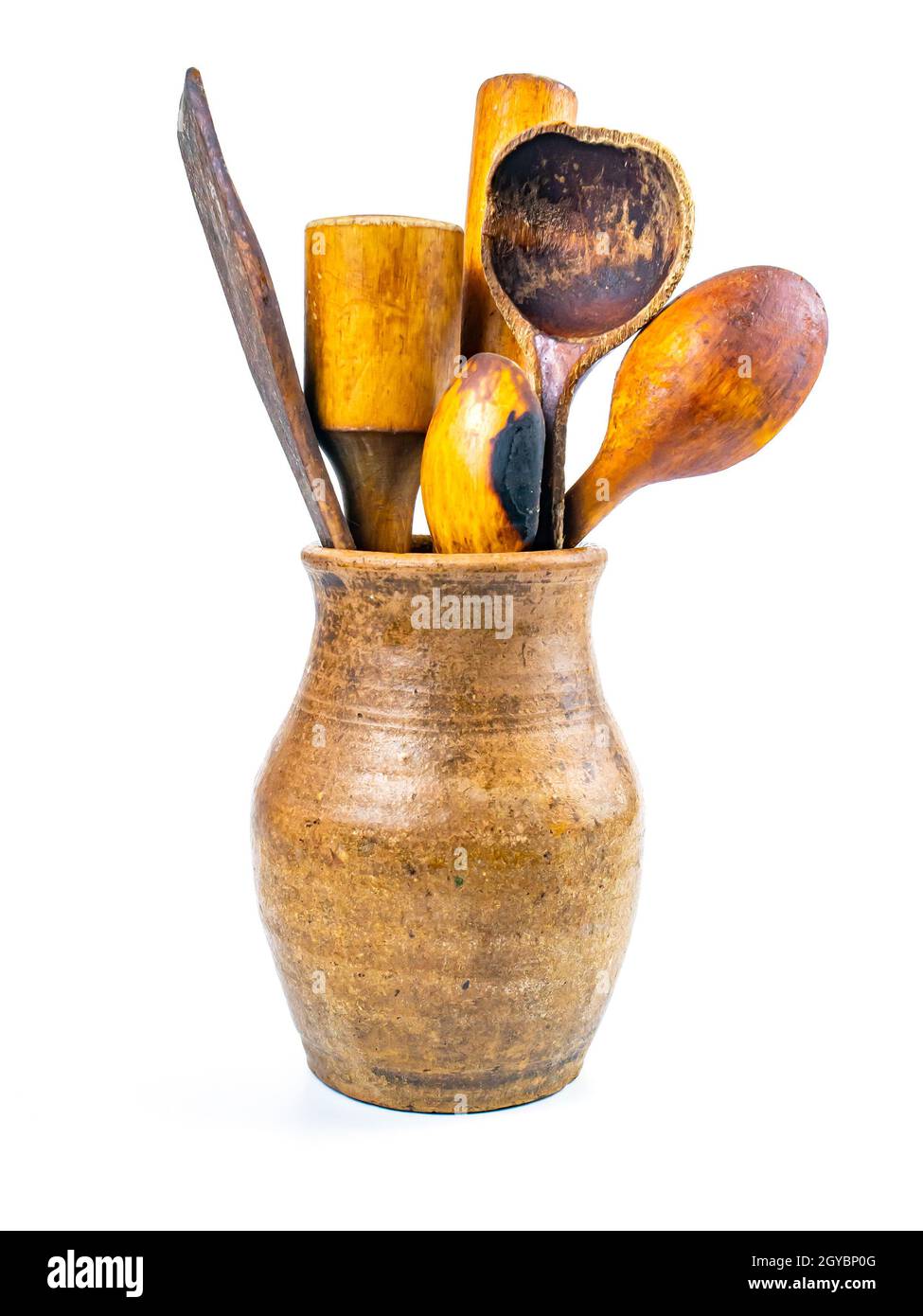 Ceramic clay jug with wooden kitchen utensils. Old kitchen utensils ...