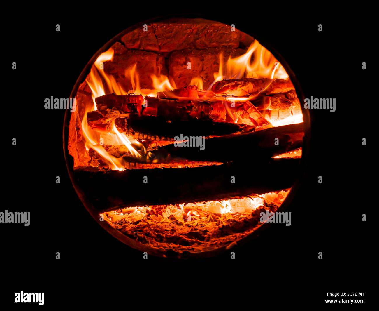 Red flame of fire in a wood stove. Fire sparks. Bright flame of a ...