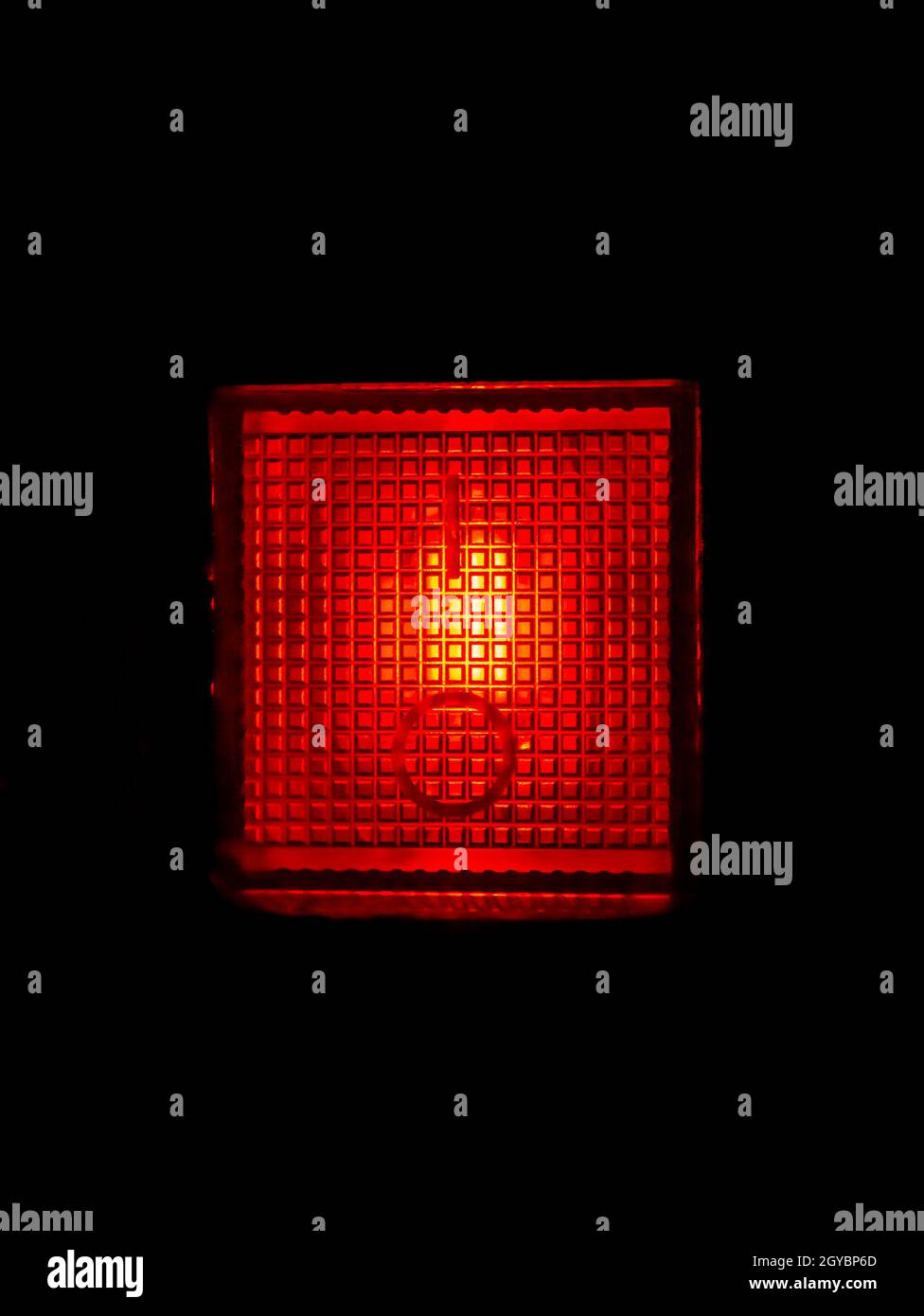 Glowing red plastic lamp in the dark. Signal light red. Night ...