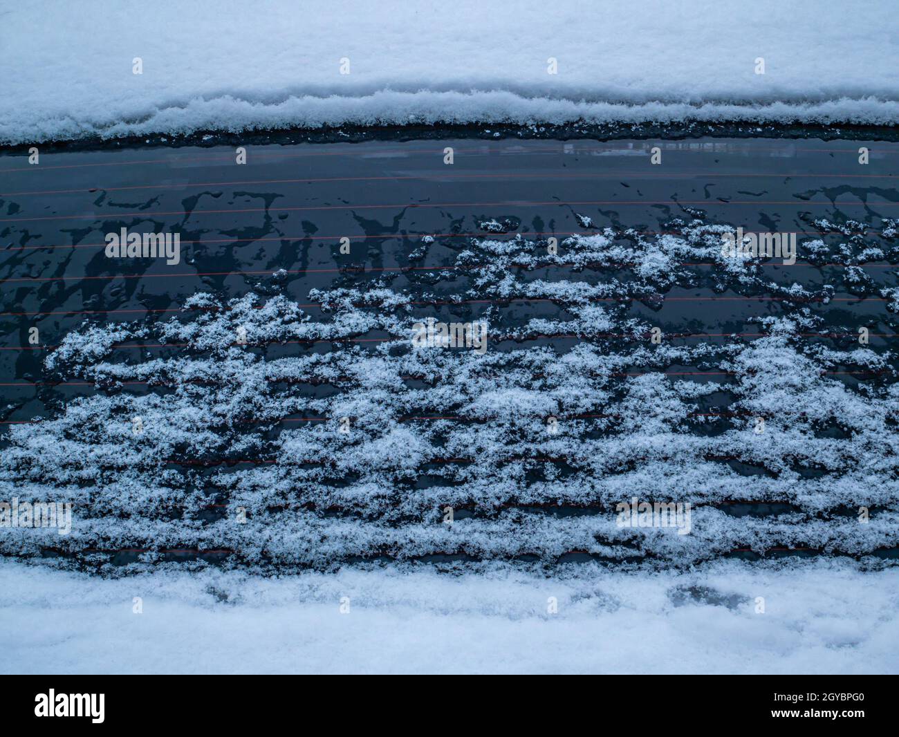Melting snow on the car window glass. Car window glass. Snow melting ...