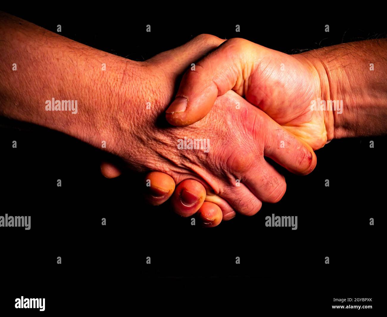 Greeting male handshake on black background at night. Male handshake ...