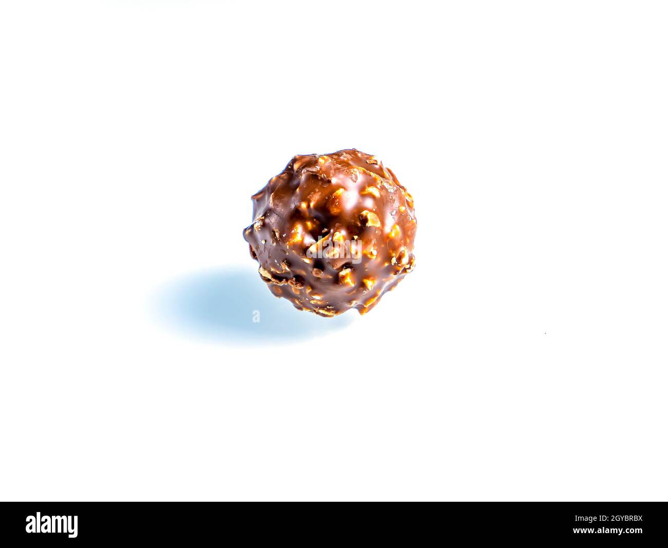Round chocolate candy on a white background. Black chocolate. Candy ...