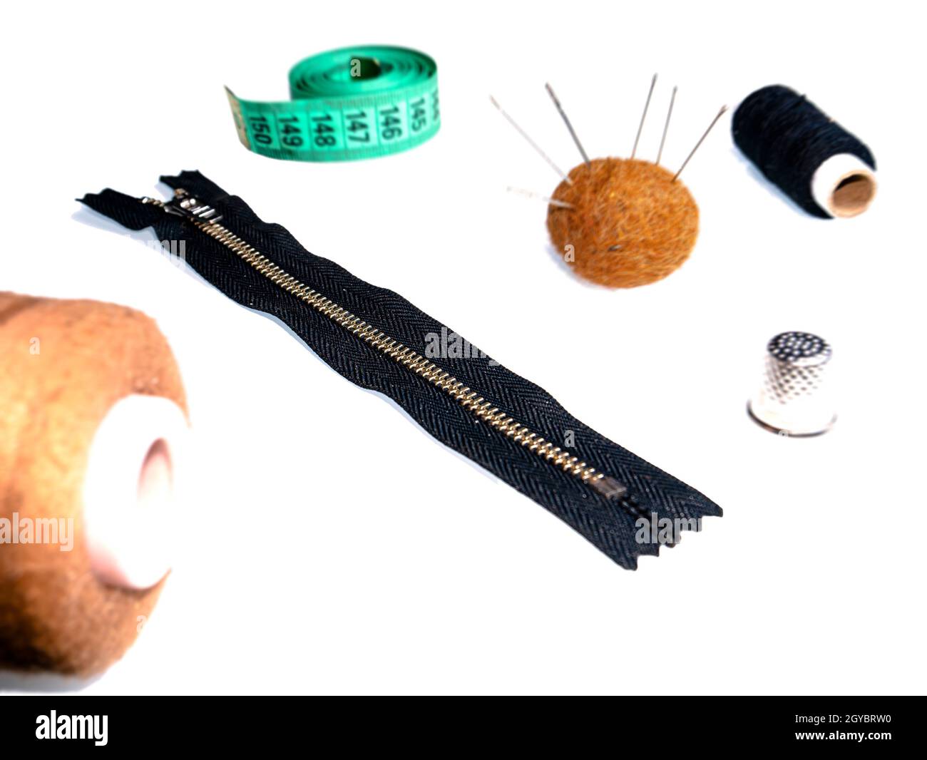 Knitted zipper and sewing accessories on a white background. Knitted ...