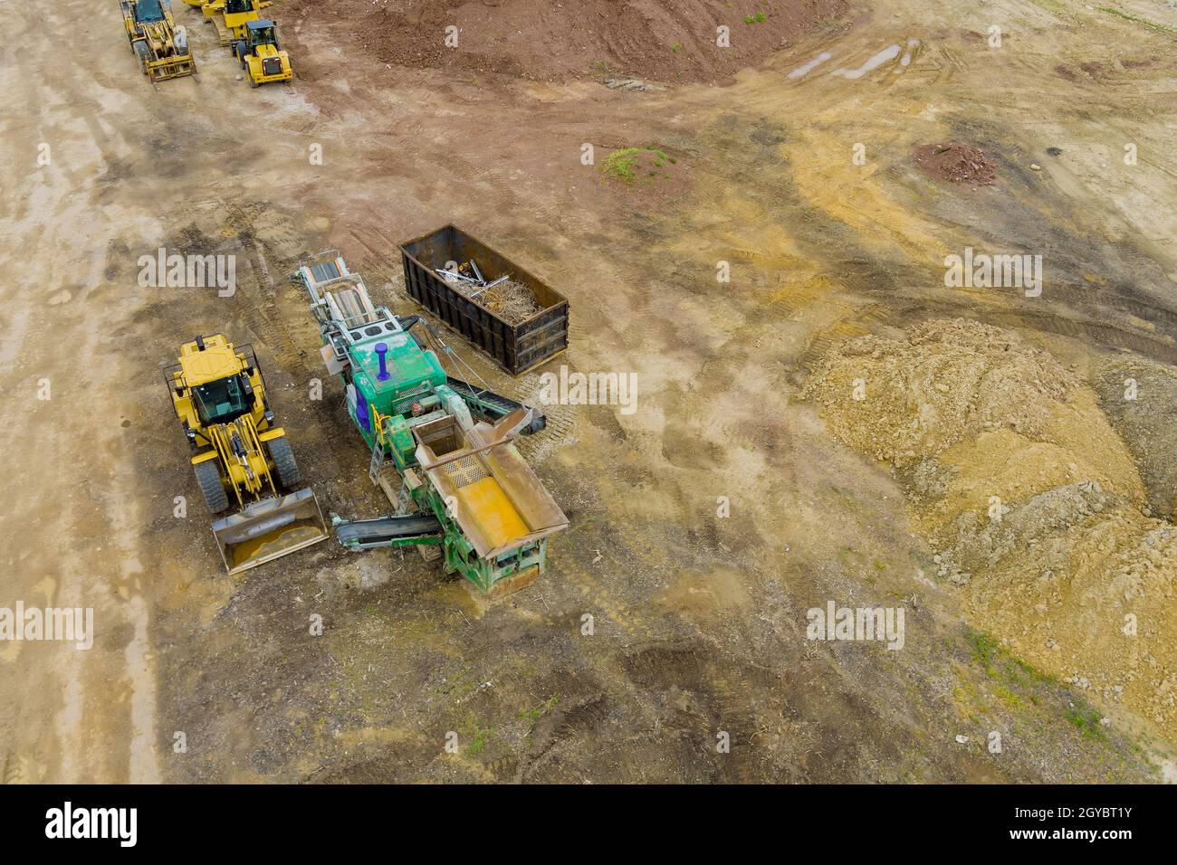 Trucks and heavy machinery clearing the land for the construction Stock ...