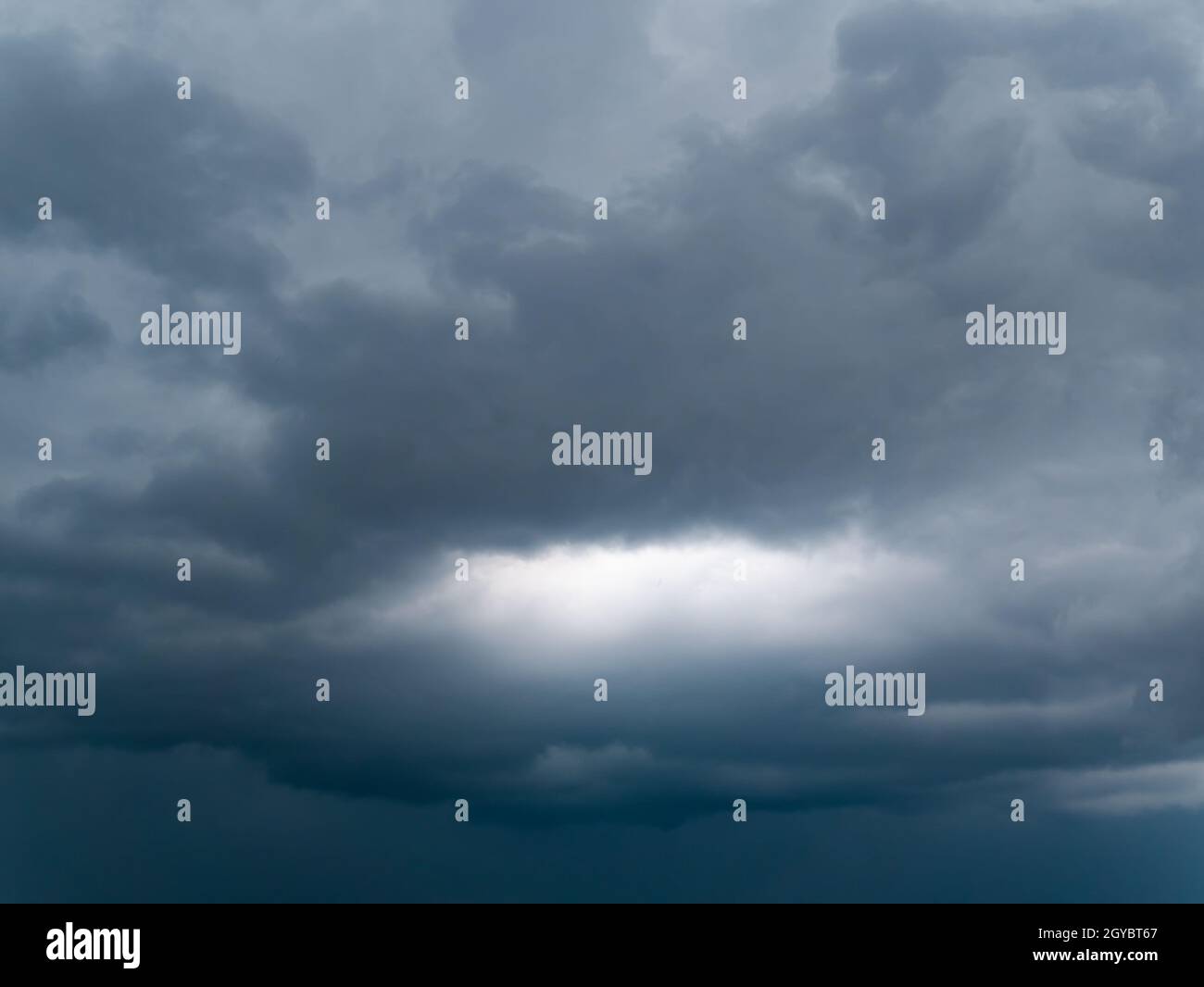 Sunlight through a thundercloud in the sky. Thunderclouds. Sunlight ...