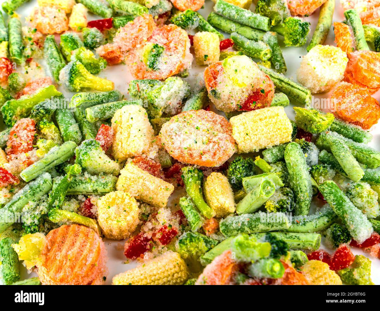 Fresh frozen vegetables on a white plate. Freezing vegetables and ...