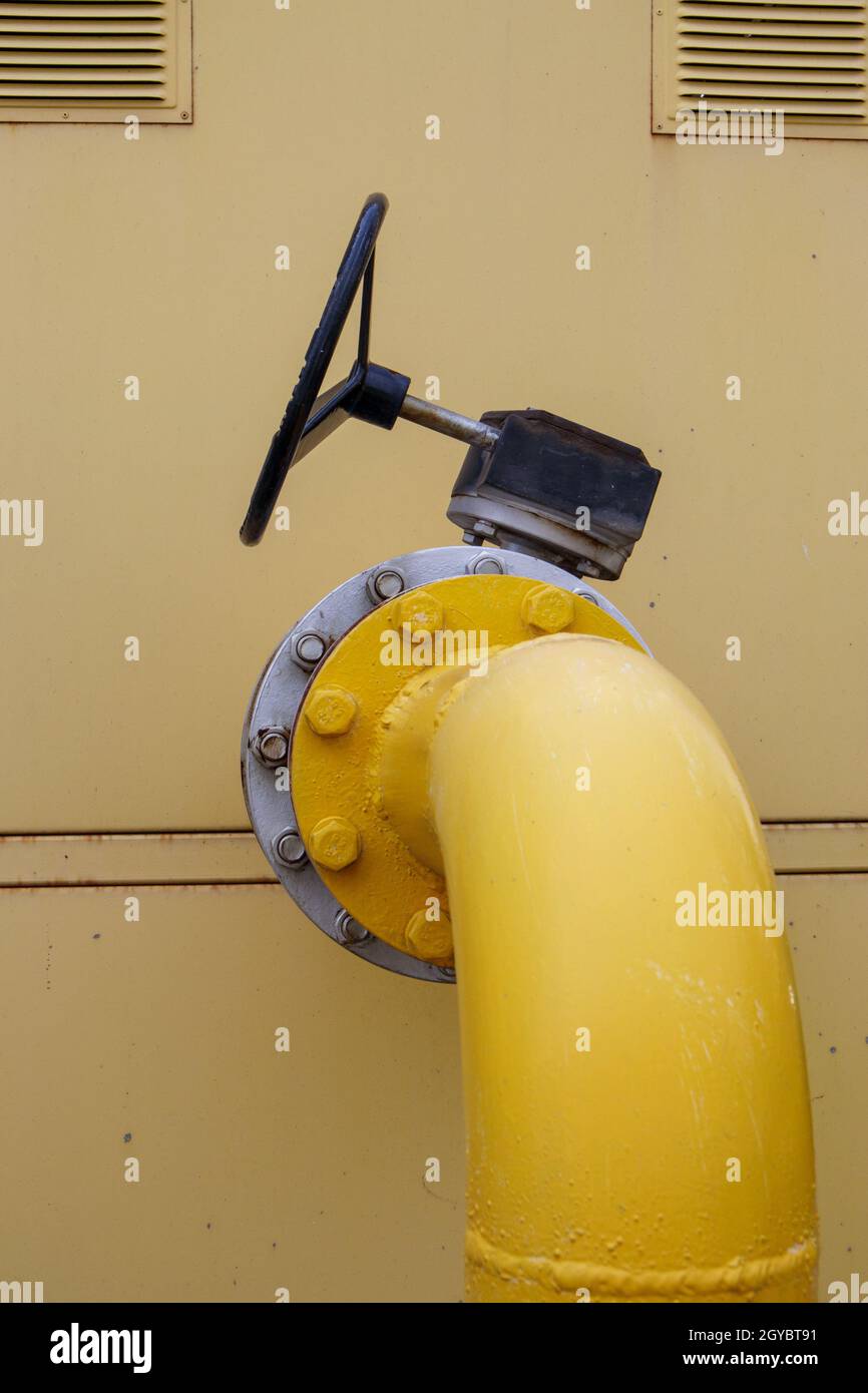 Yellow gas pipe with a tap. Oil pipeline fittings in the oil and gas ...