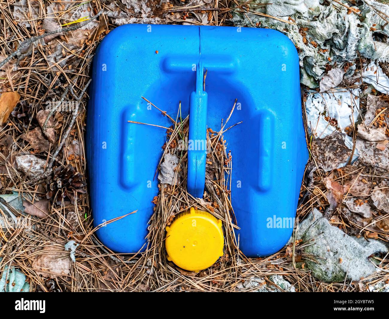 The blue plastic canister is buried in the ground. Container for ...
