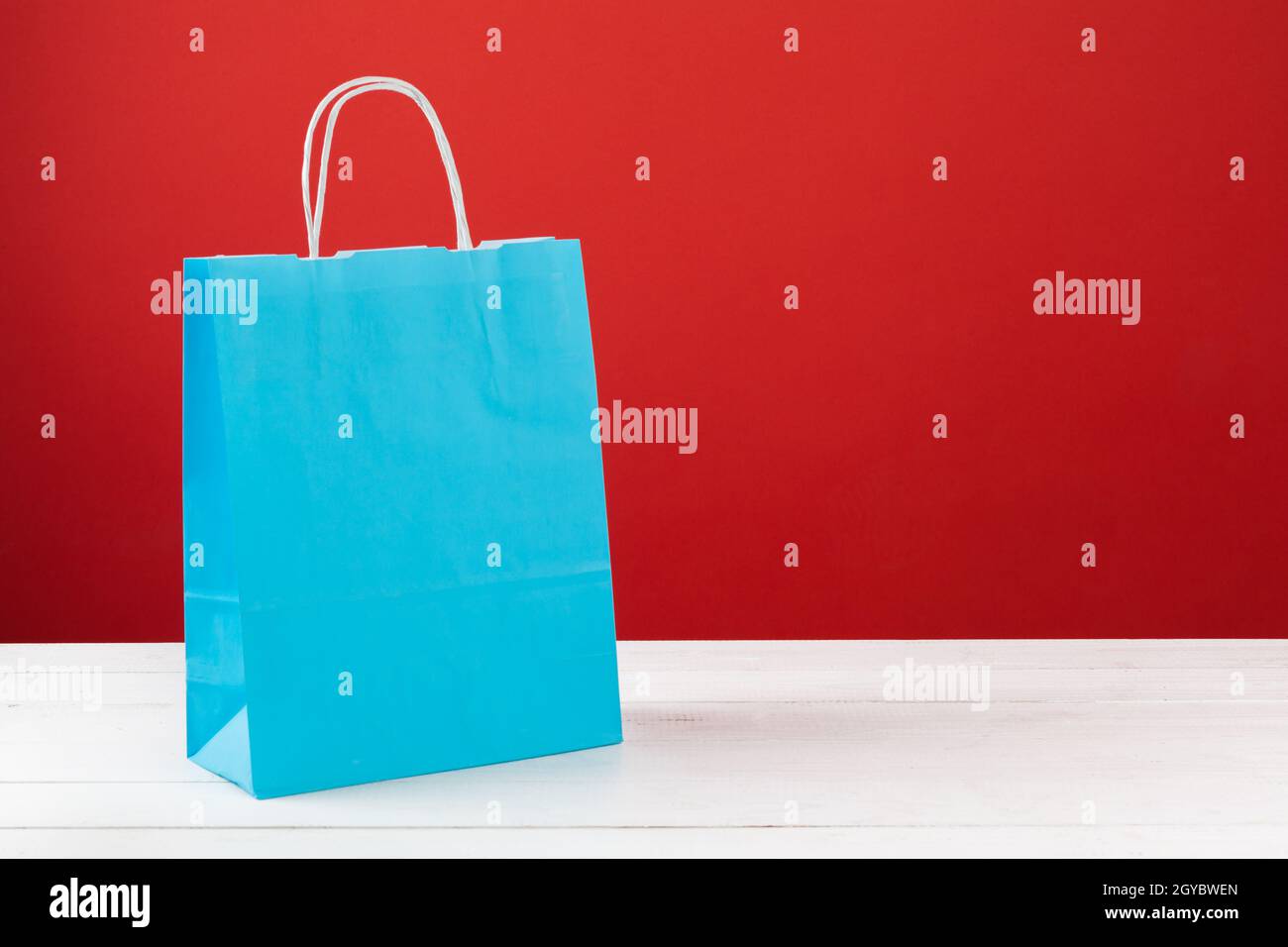 Paper shopping bags with copy space on red background Stock Photo - Alamy