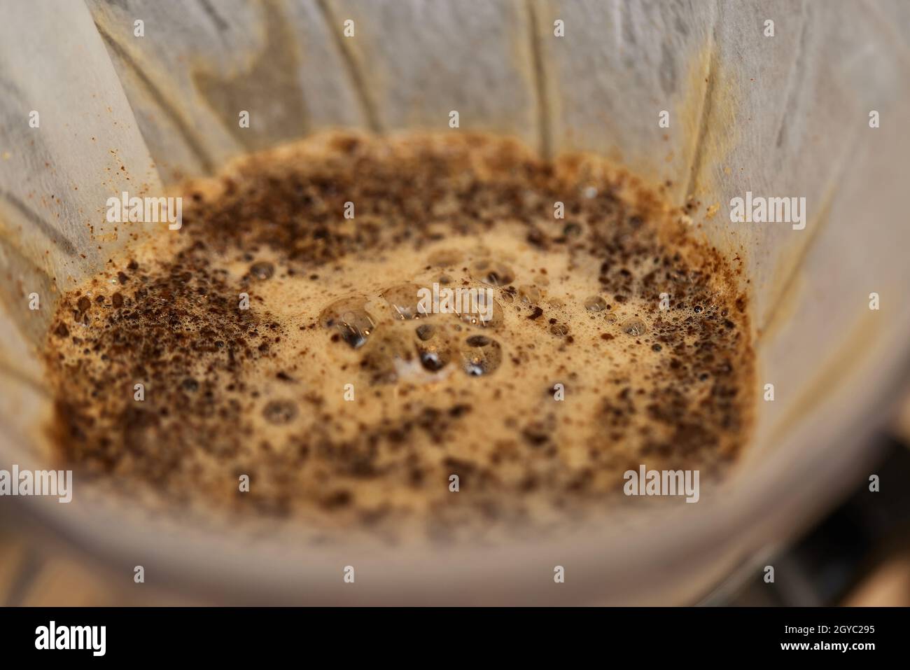 grounded coffee in filter to prepare freshly brewed coffee. close-up ...